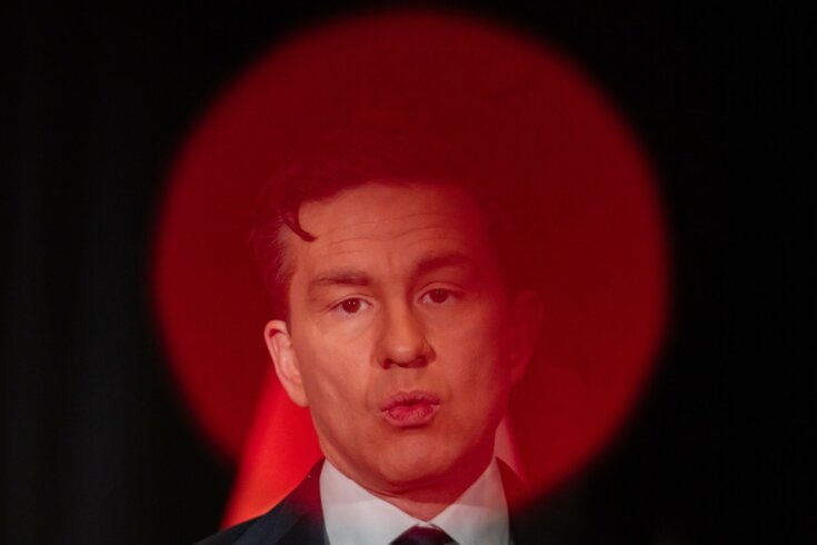 A photo of Pierre Poilievre with a red circle of light spotlighting his ...