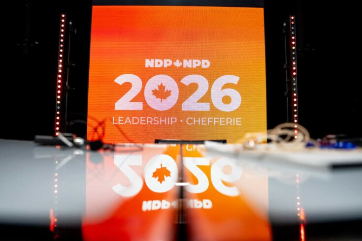 Photo of the NDP leadership debate stage. An orange banner reads NDP ...