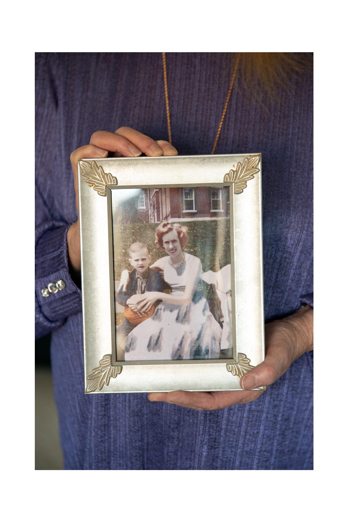 Photo of Betty Bellchambers holding an old photo of her and her son ...