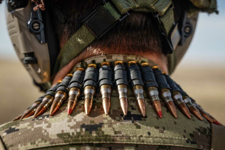 A soldier of the 41 Canadian Brigade Group carries ammunition for a C9 ...